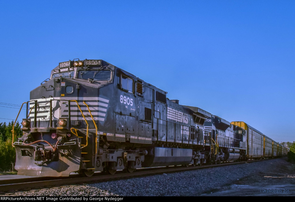 NS 8905 leads a loaded aqto train near Camp Croft